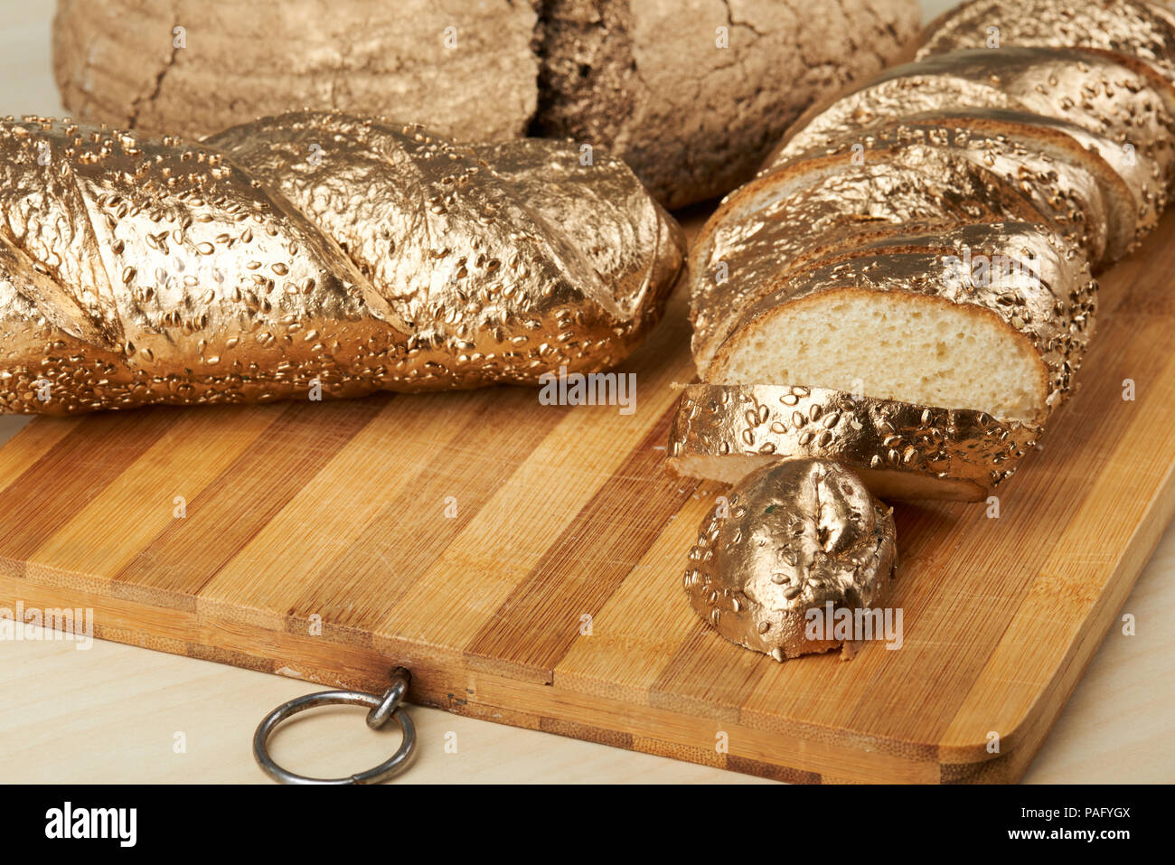 Macro of metallic gold bread lay on wooden board close-up Stock Photo ...