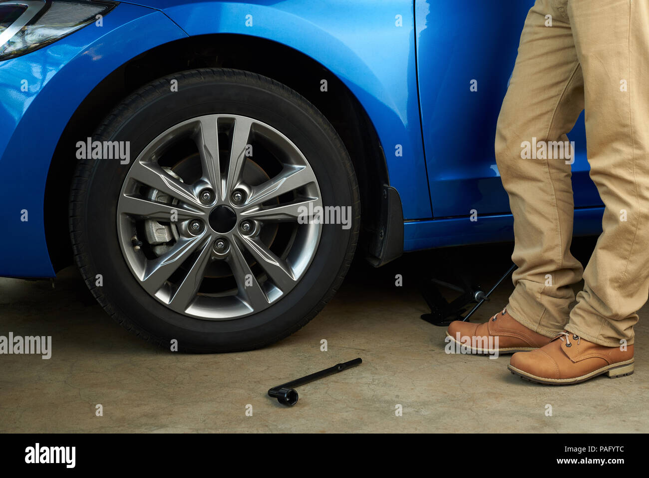 Lifting up car for changing wheel. Replacing damaged car wheel Stock ...