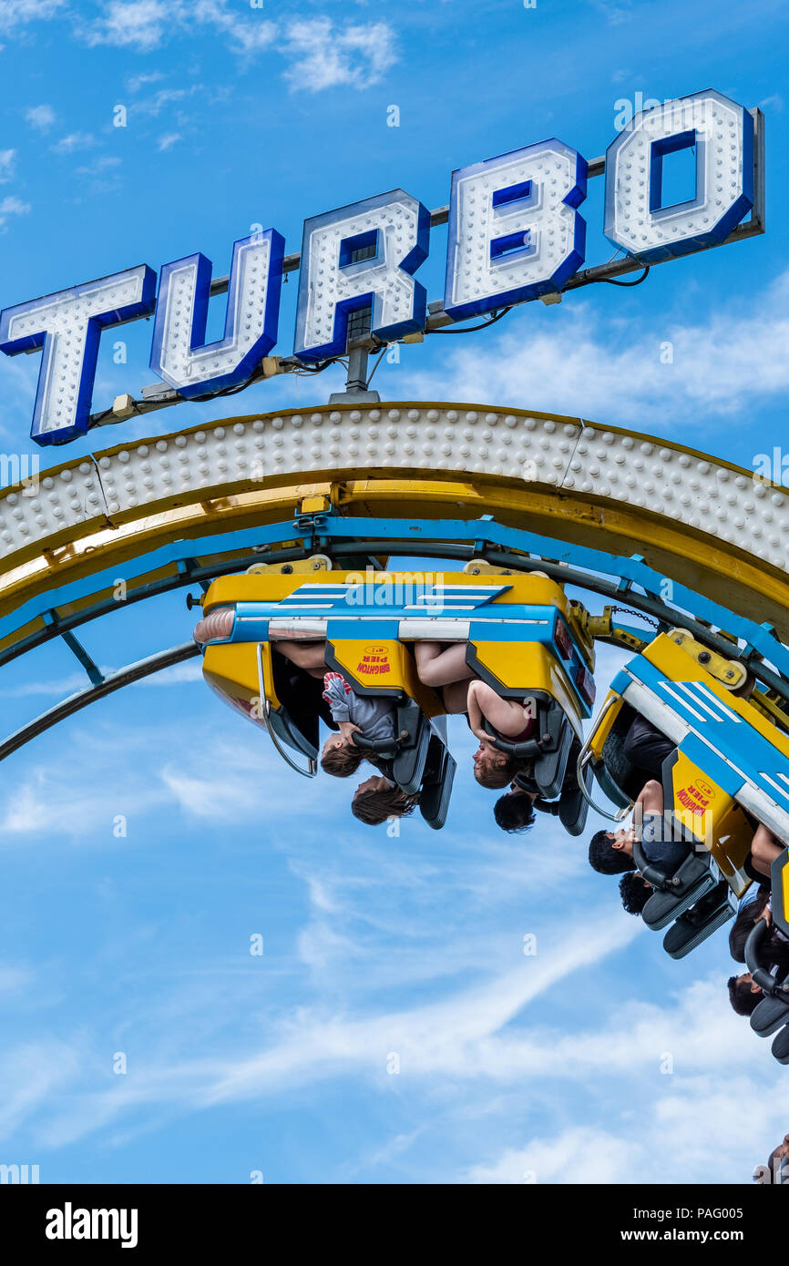 People ride upside down on the Turbo Roller Coaster in Brighton, UK ...