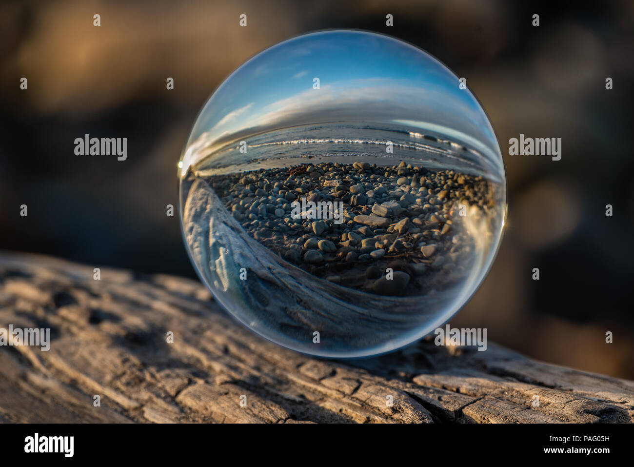 Cobblestone shoreline of the beach distorted by the spherical lens on ...
