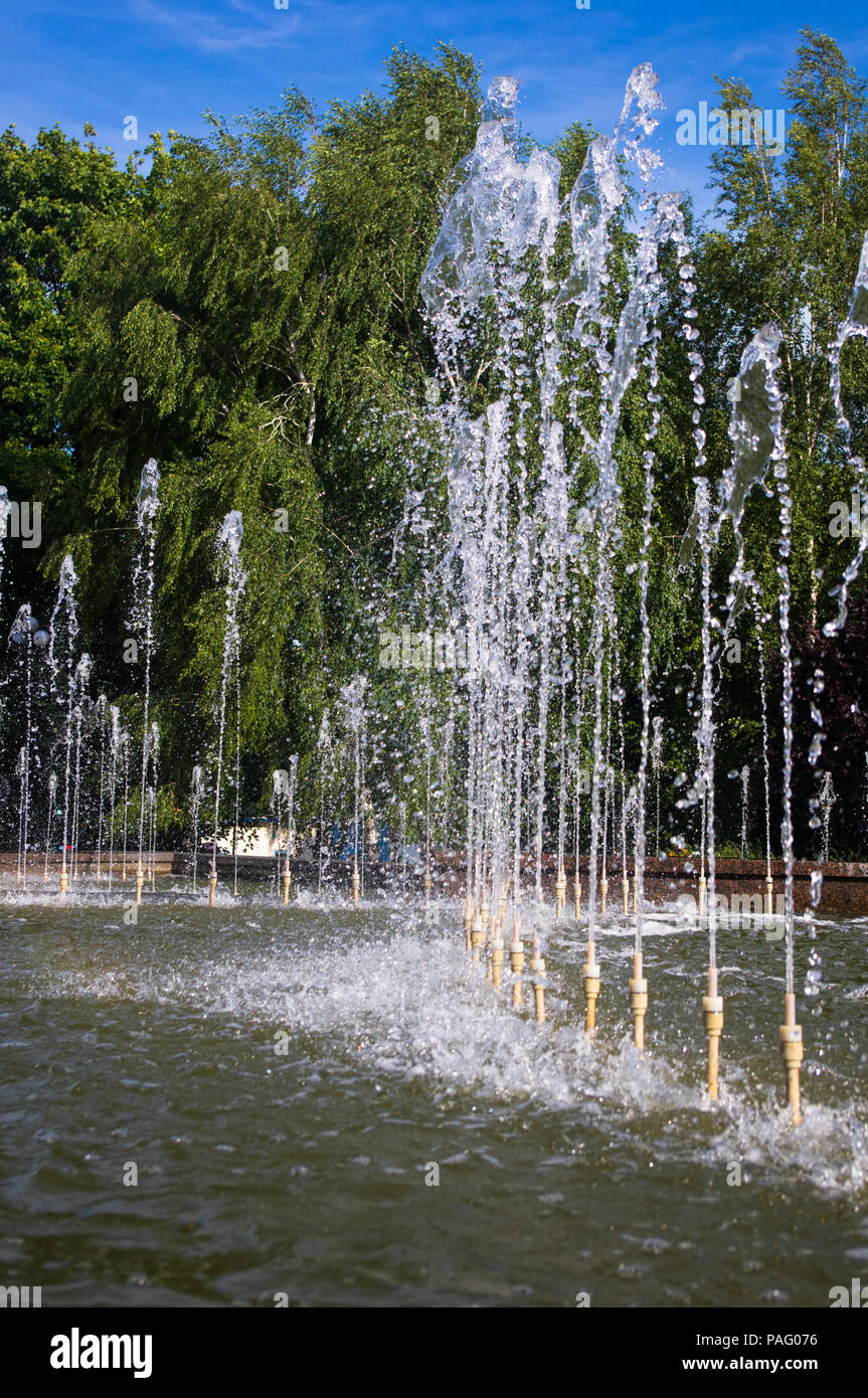 Fountain in city park on hot summer day, beautiful bright streams of ...