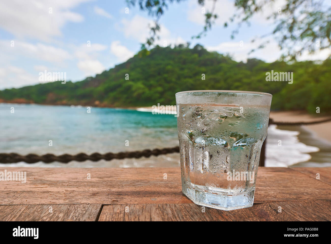 Glass of water with dew stand on wooden table Stock Photo - Alamy