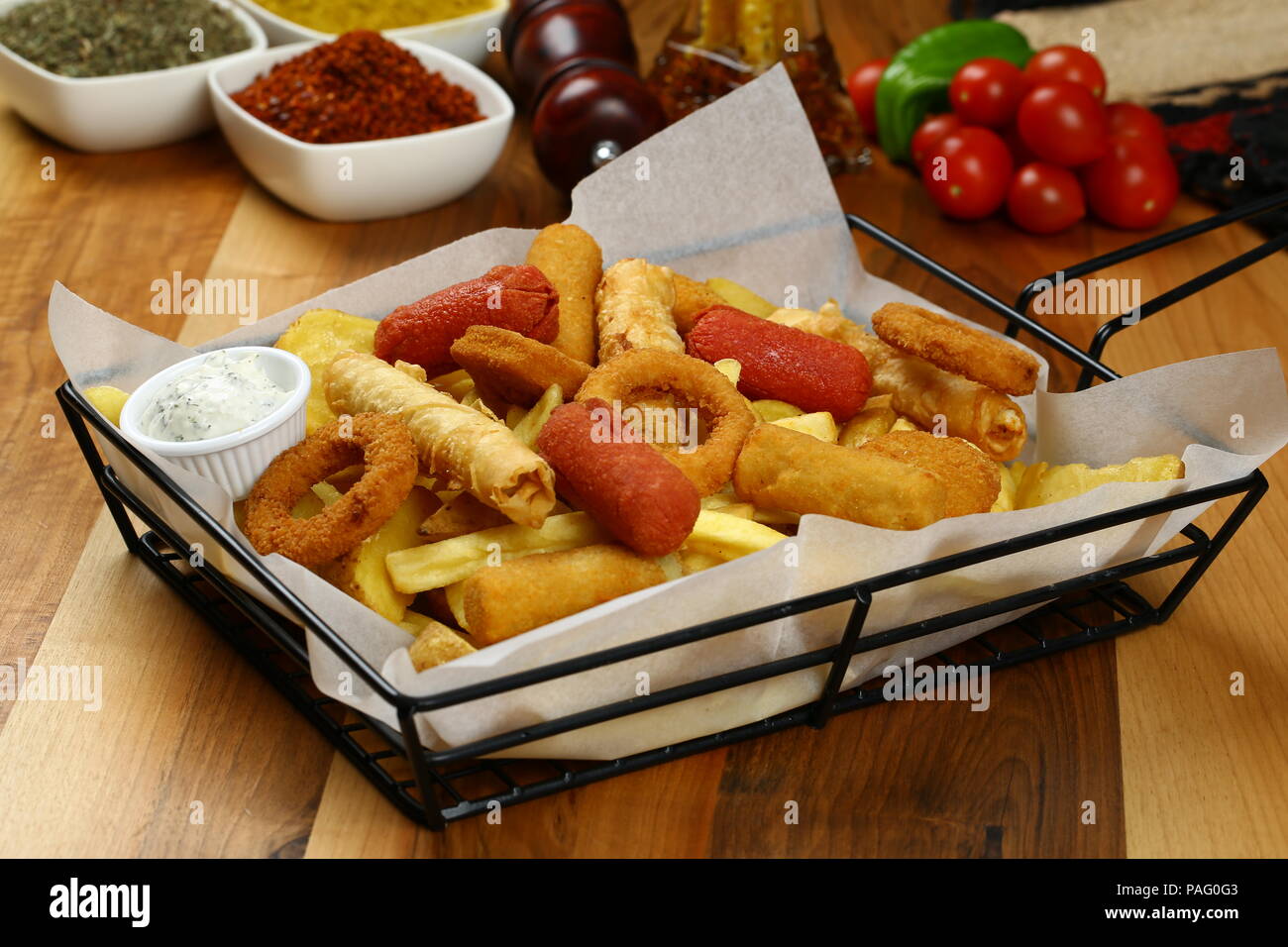 Mixed appetizer of french fries, fried sasusage, fried zucchini, pastry ...