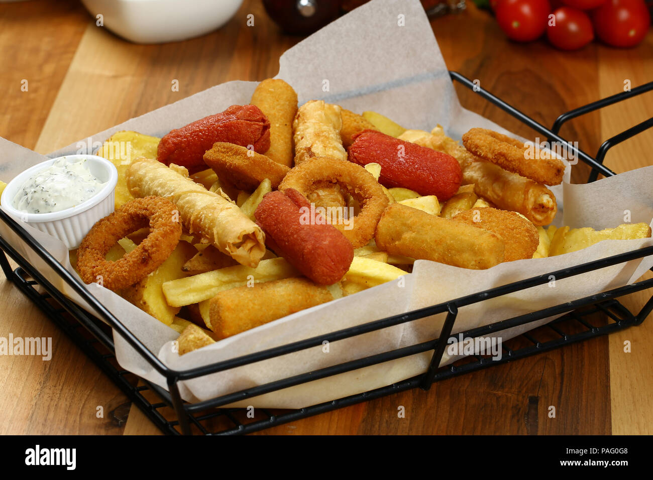 Mixed appetizer of french fries, fried sasusage, fried zucchini, pastry ...