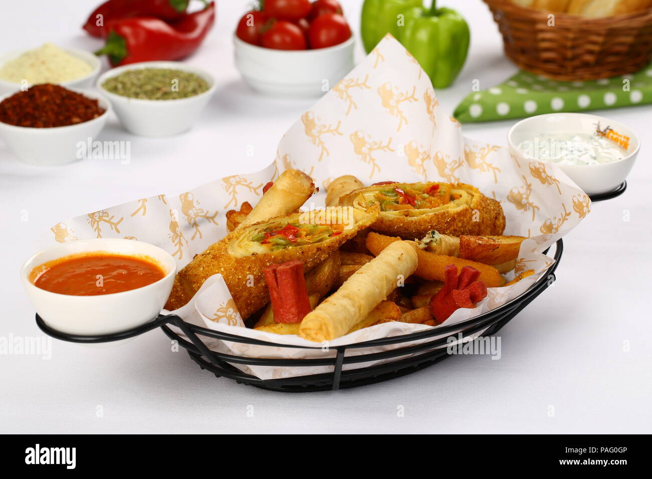Mixed appetizer of french fries, fried sasusage, fried zucchini, pastry ...