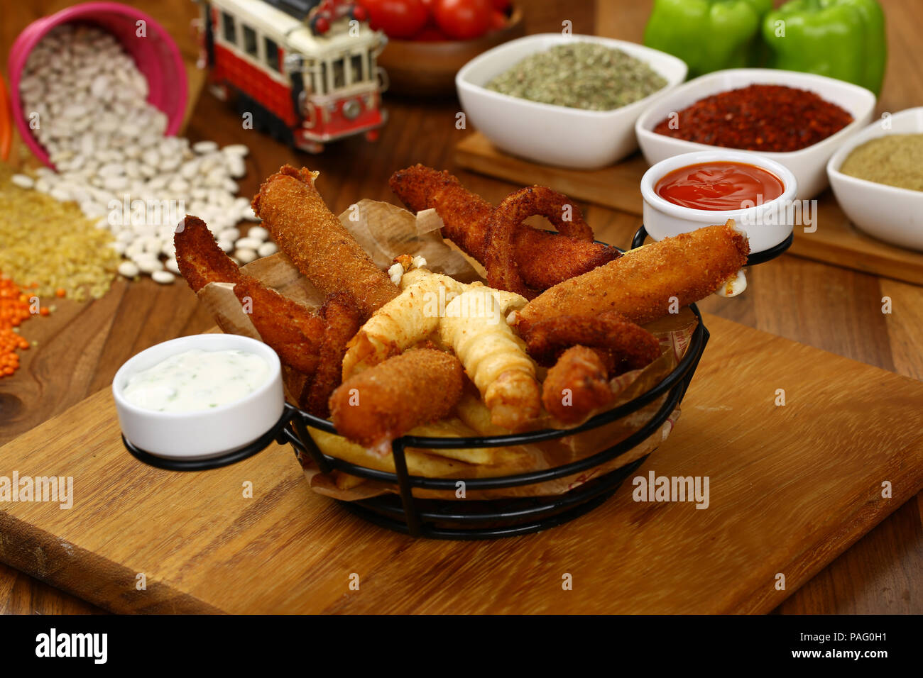 Mixed appetizer of french fries, fried sasusage, fried zucchini, pastry ...