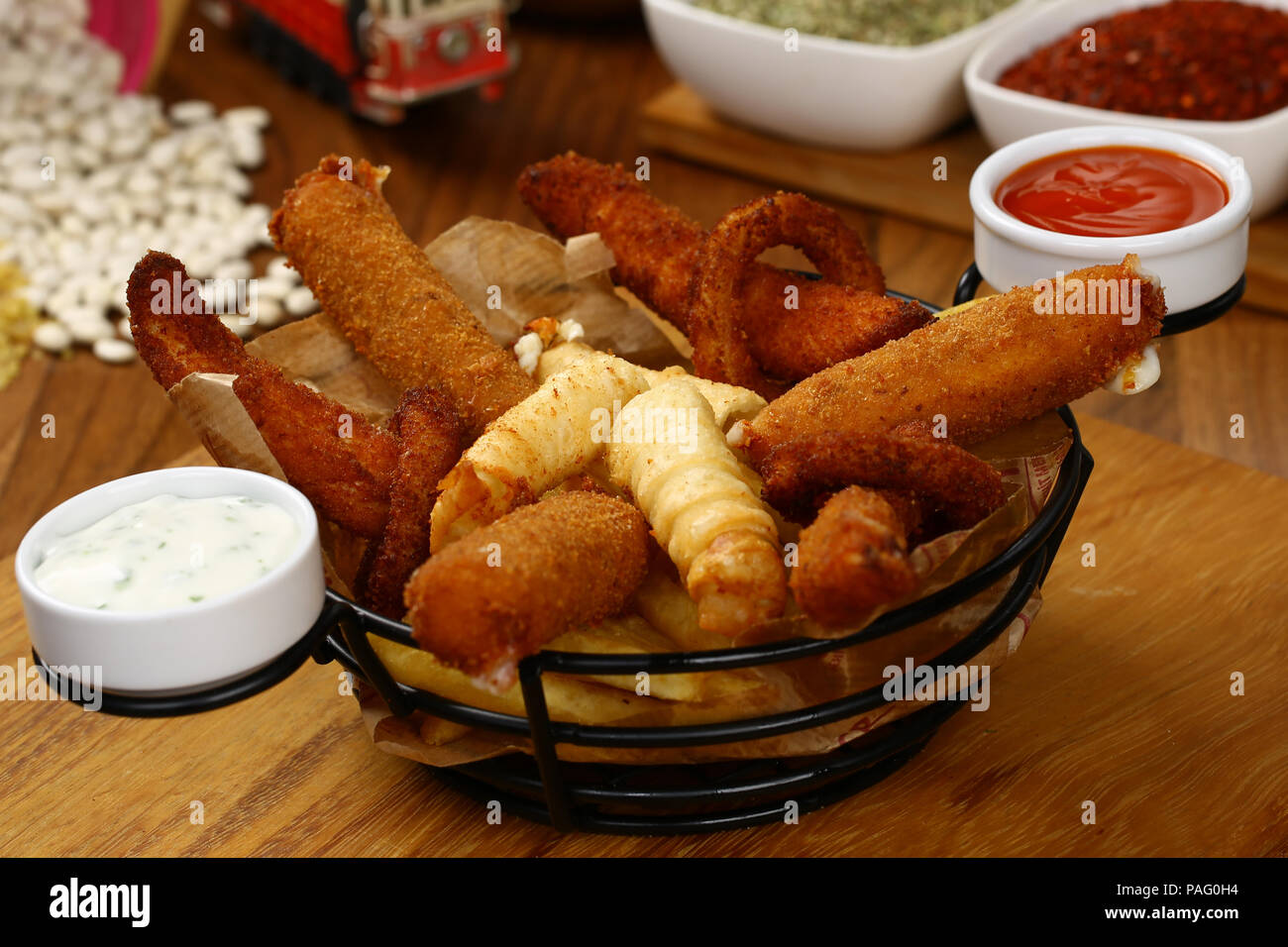 Mixed appetizer of french fries, fried sasusage, fried zucchini, pastry ...