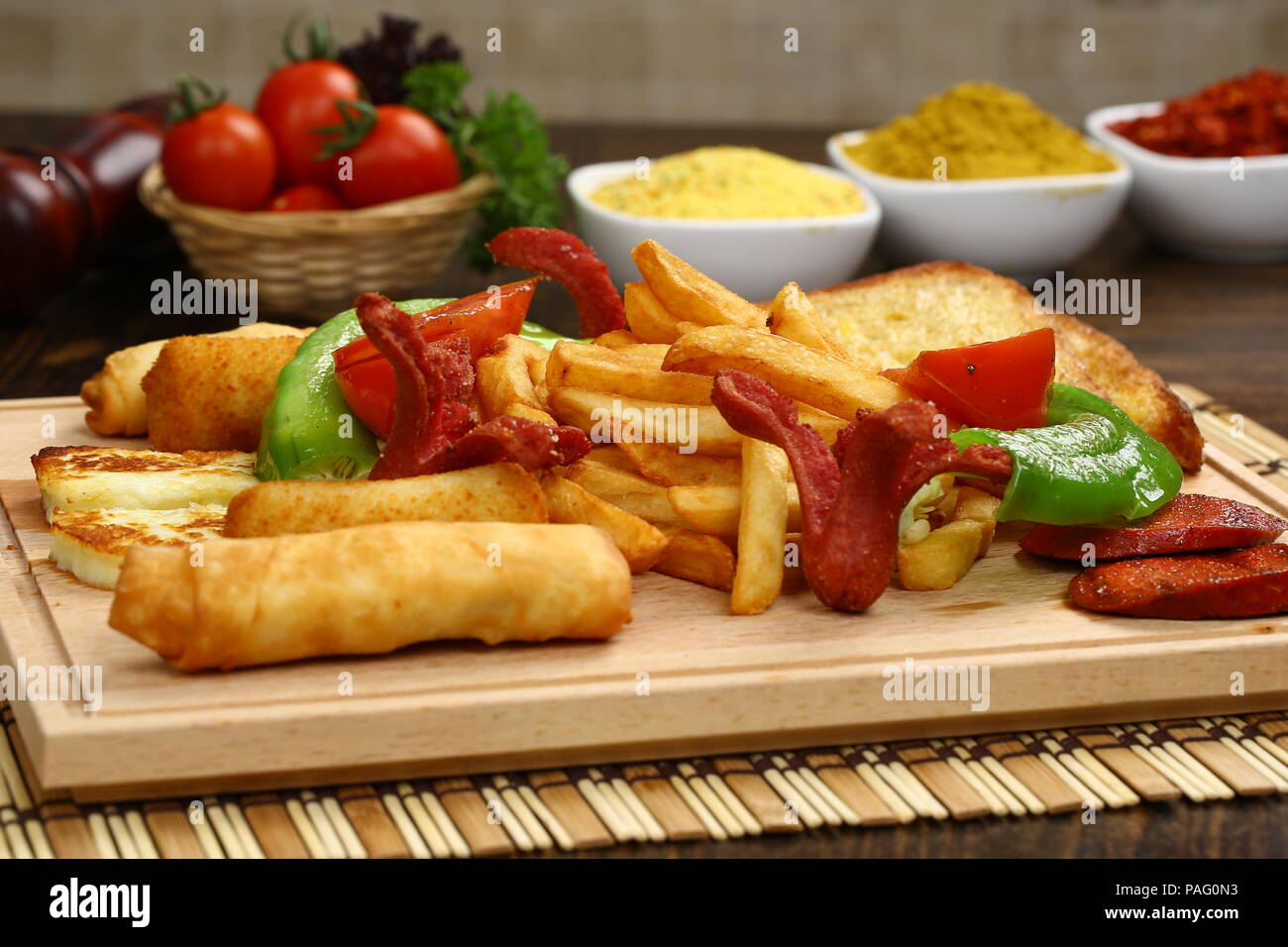 Mixed appetizer of french fries, fried sasusage, fried zucchini, pastry ...