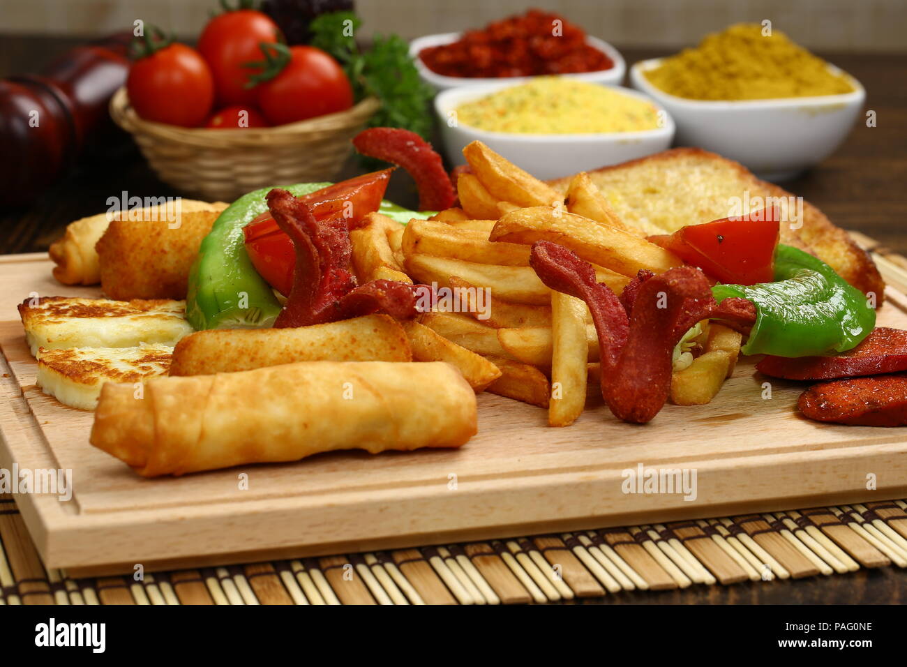 Mixed appetizer of french fries, fried sasusage, fried zucchini, pastry ...