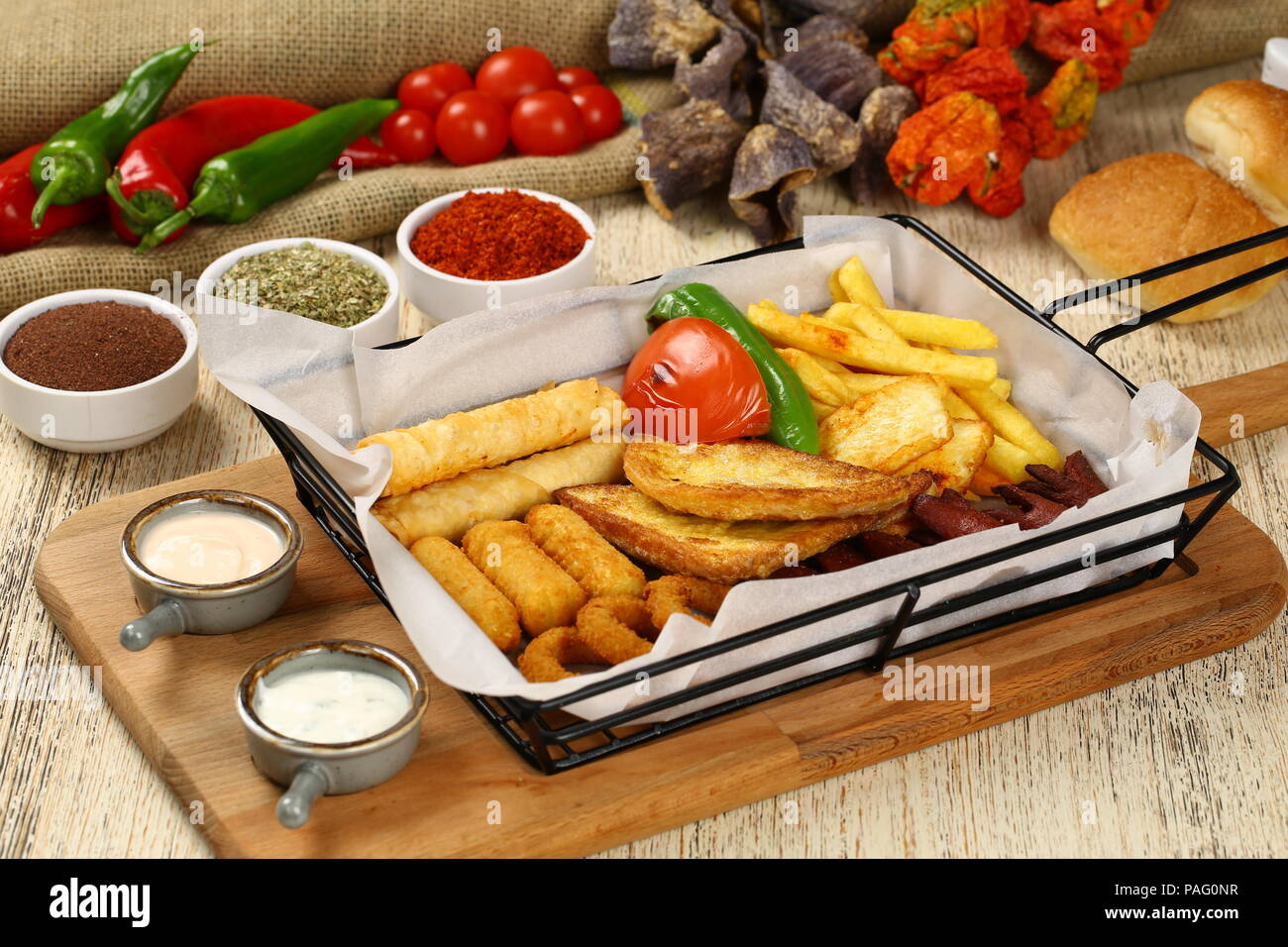 Mixed appetizer of french fries, fried sasusage, fried zucchini, pastry ...