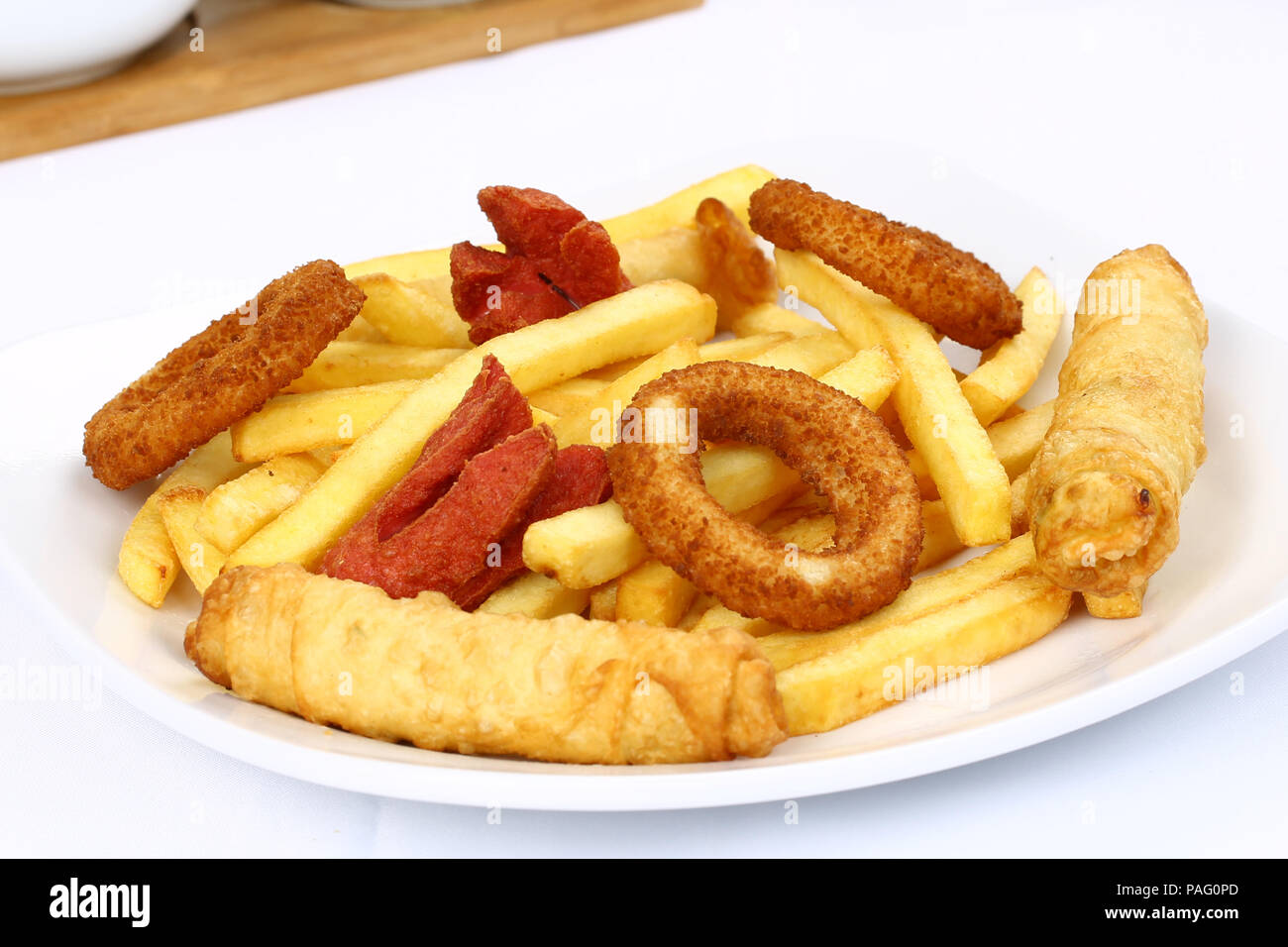 Mixed appetizer of french fries, fried sasusage, fried zucchini, pastry ...