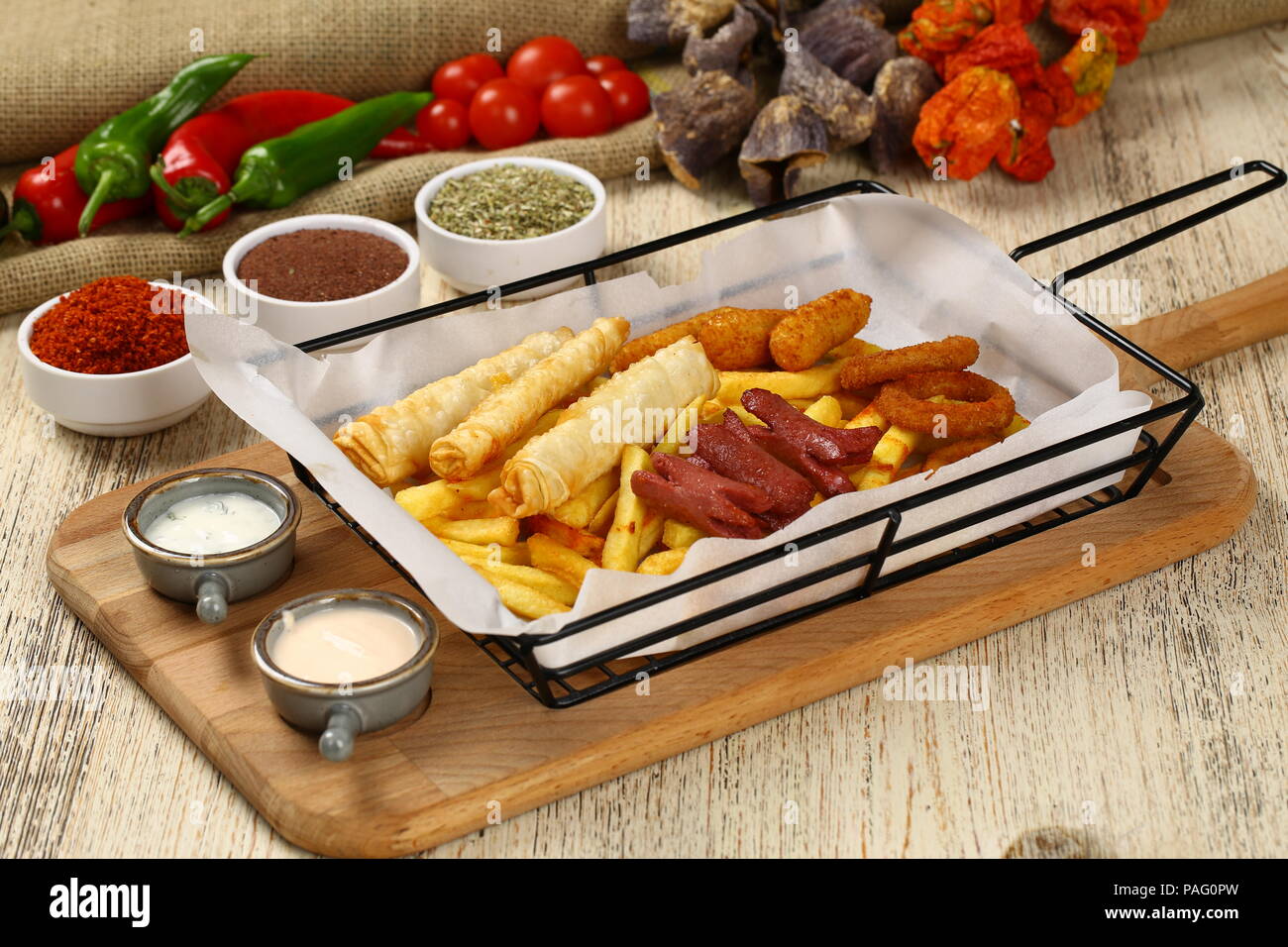 Mixed appetizer of french fries, fried sasusage, fried zucchini, pastry ...