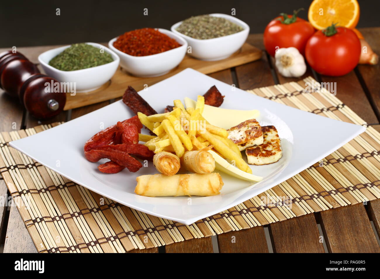 Mixed appetizer of french fries, fried sasusage, fried zucchini, pastry ...