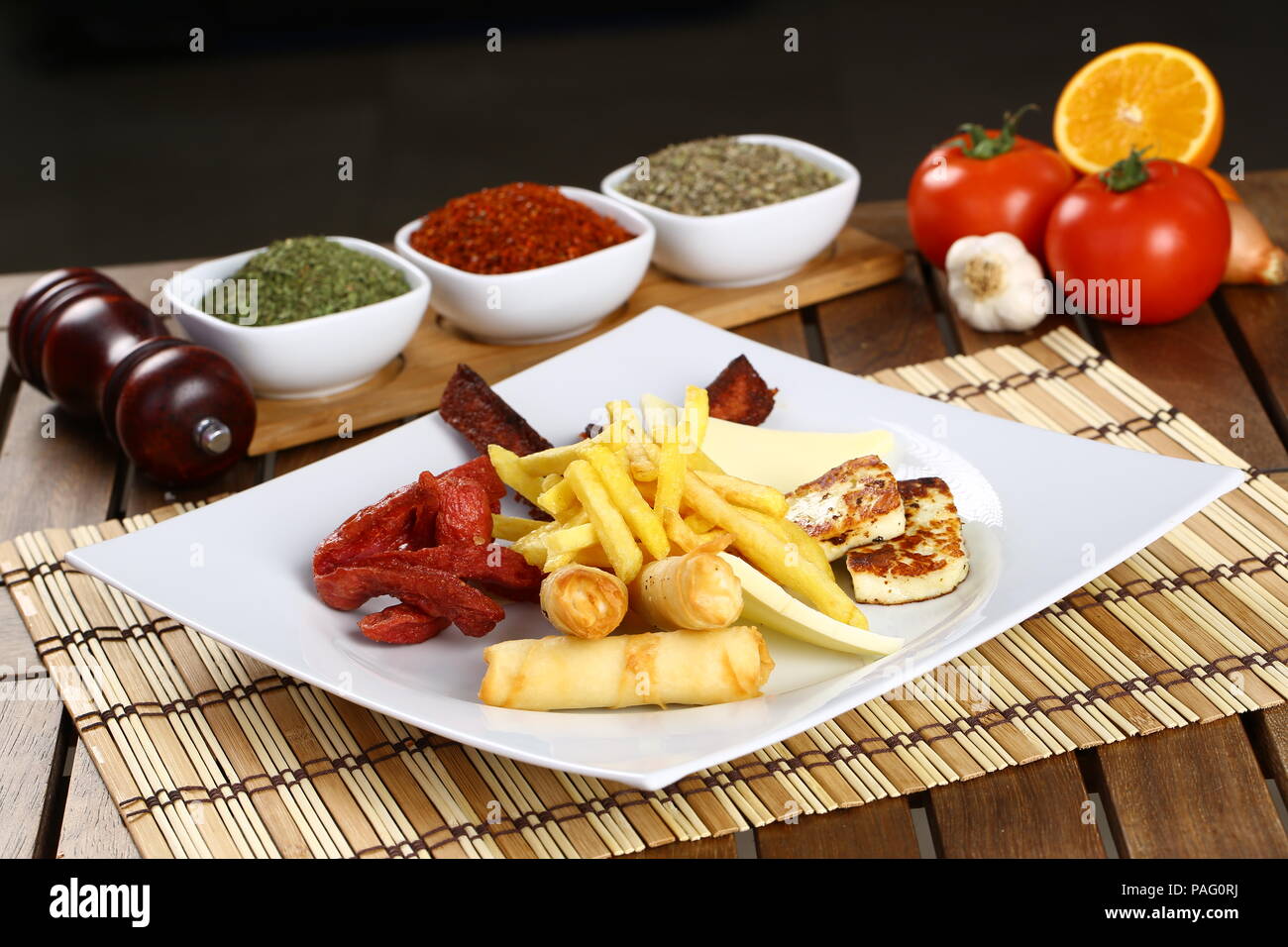 Mixed appetizer of french fries, fried sasusage, fried zucchini, pastry ...