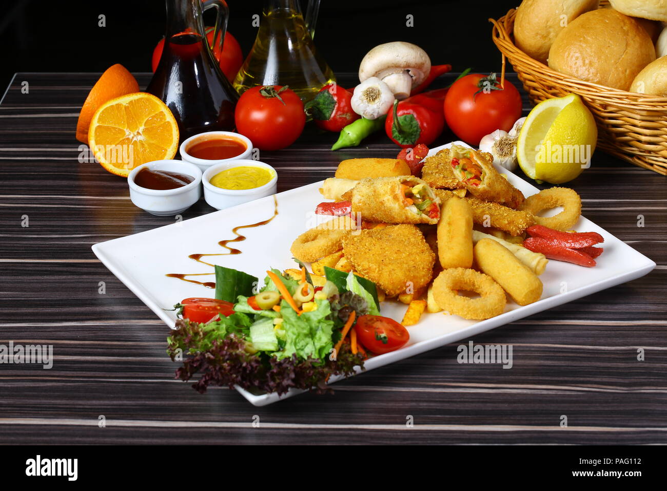 Mixed appetizer of french fries, fried sasusage, fried zucchini, pastry ...