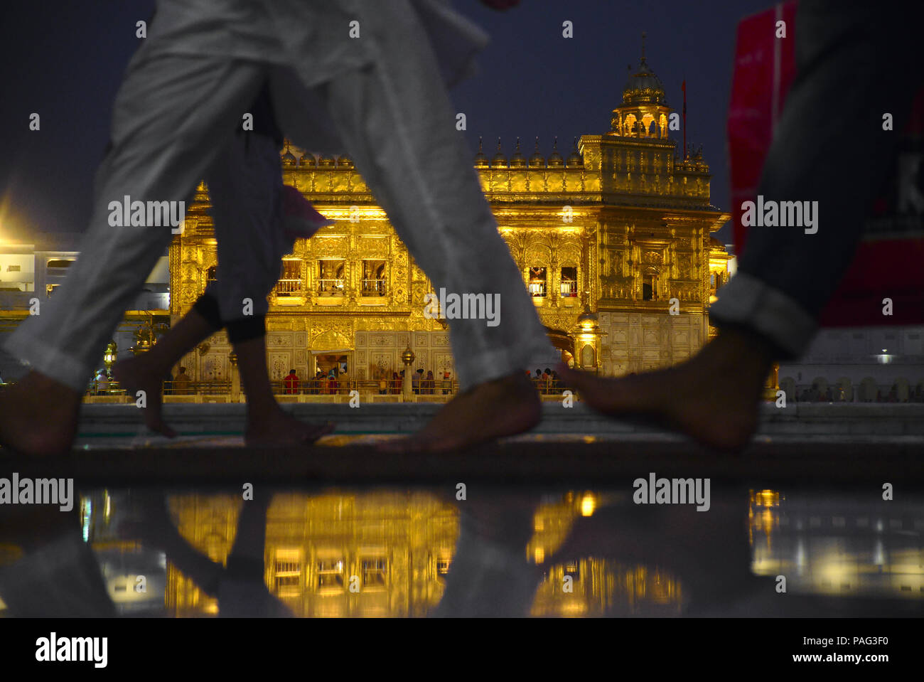 Pilgrims walking barefoot at Golden Temple, as no shoes are allowed ...