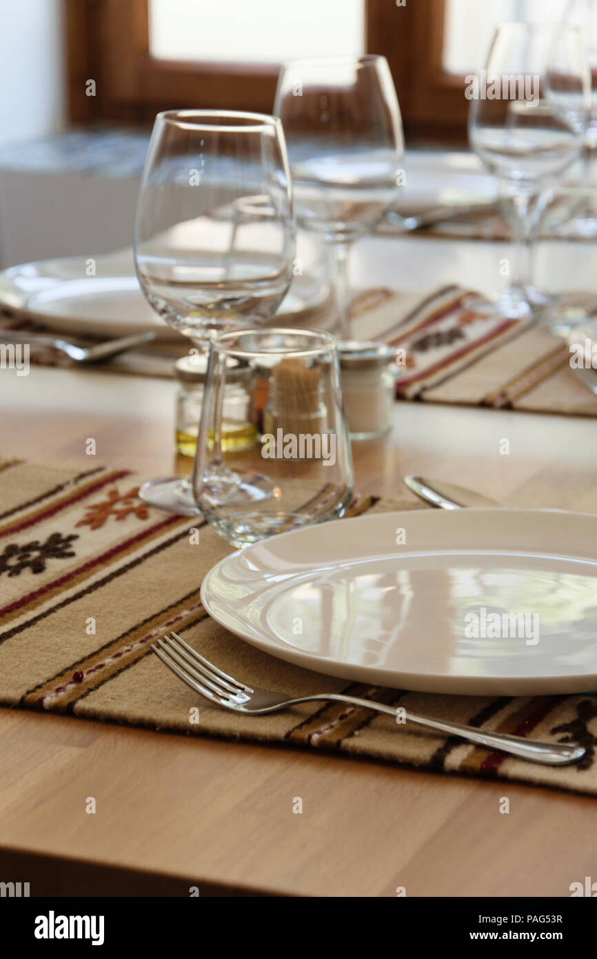 Elegant table set in traditional restaurant, mix between rustic and ...