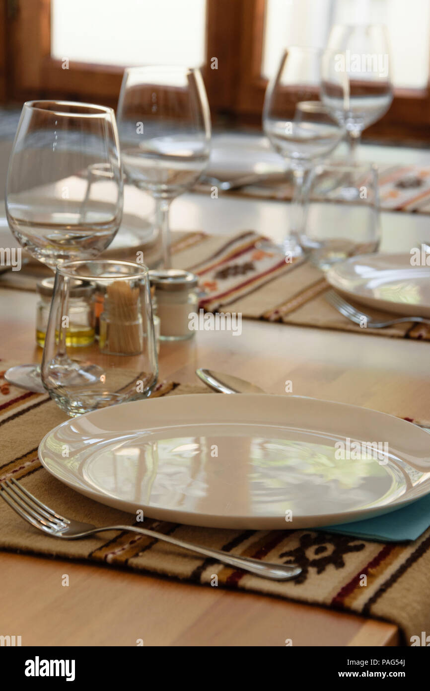 Elegant table set in traditional restaurant, mix between rustic and ...