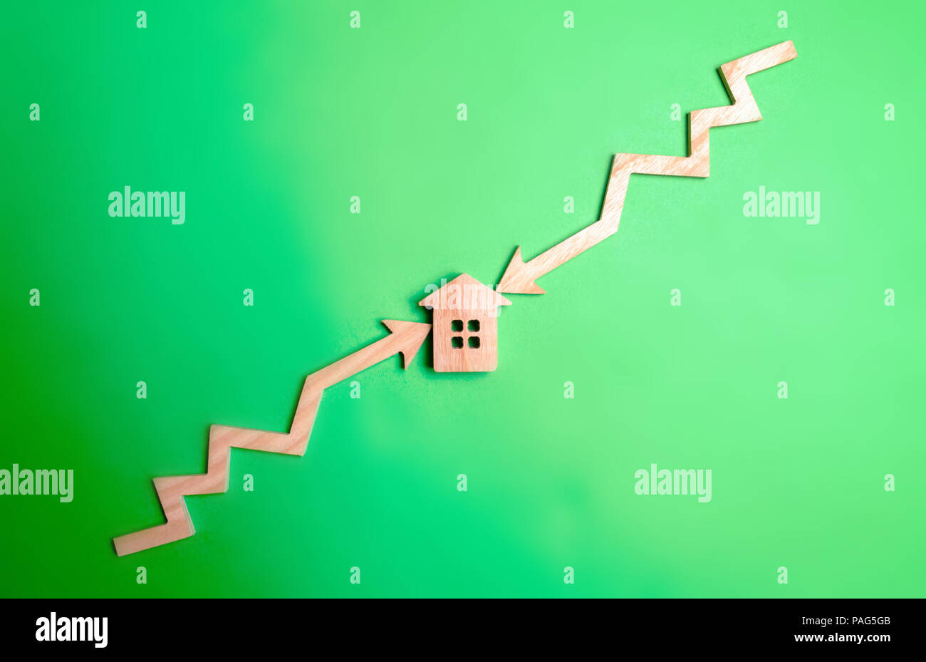 Two wooden arrows point to a wooden house in the middle between them ...