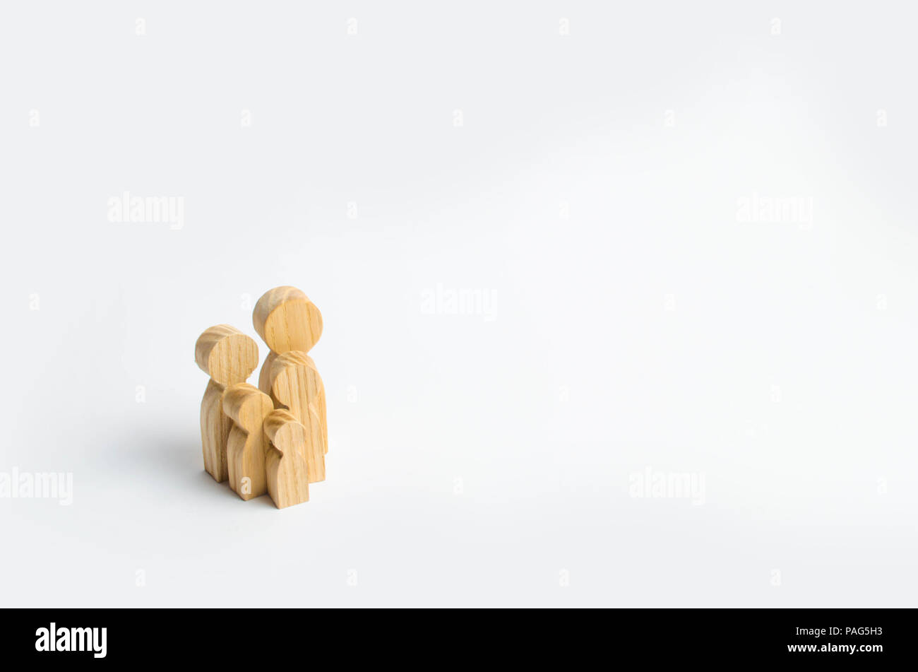 Wooden figurines of people in the shape of a family on a white ...