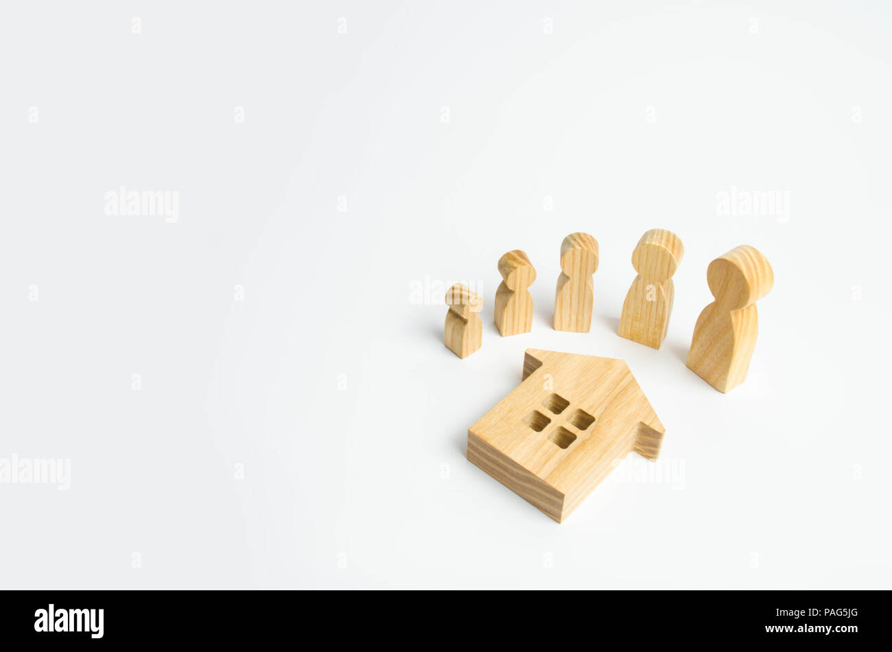 Wooden figures of people from small to large stand around the house ...