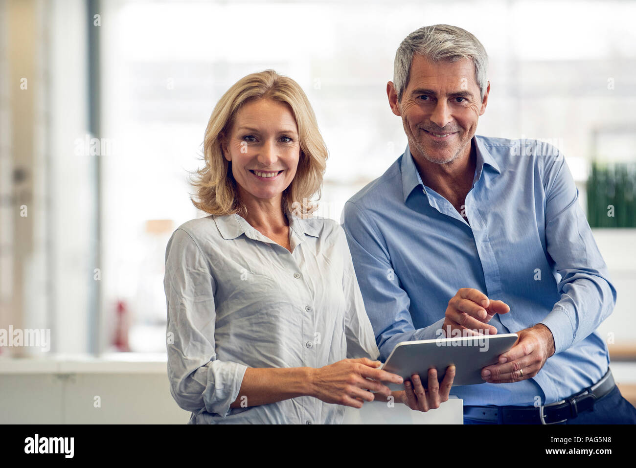 Two partners using tablet hi-res stock photography and images - Alamy