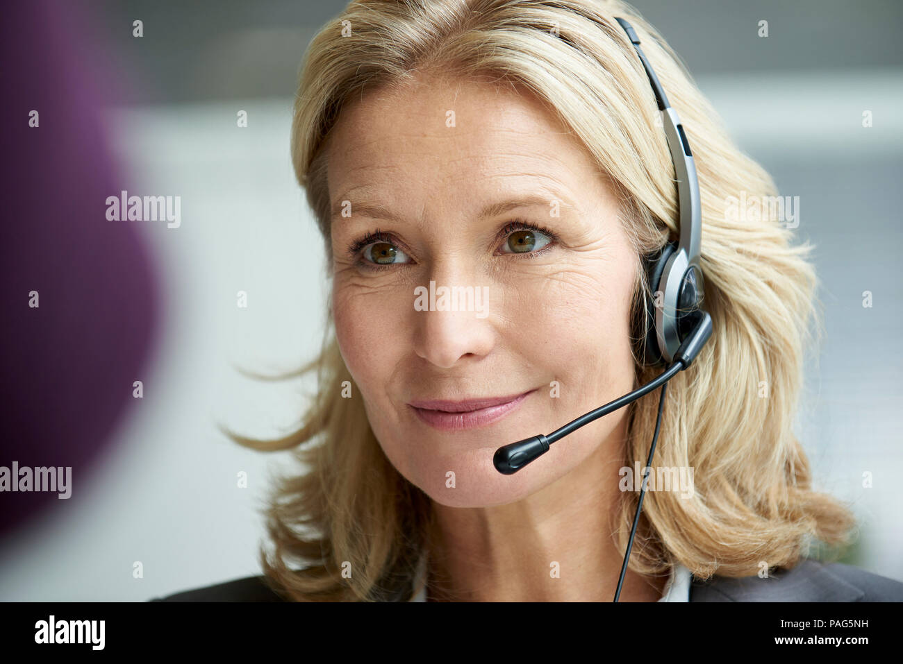 Telecaller with headset Stock Photo - Alamy