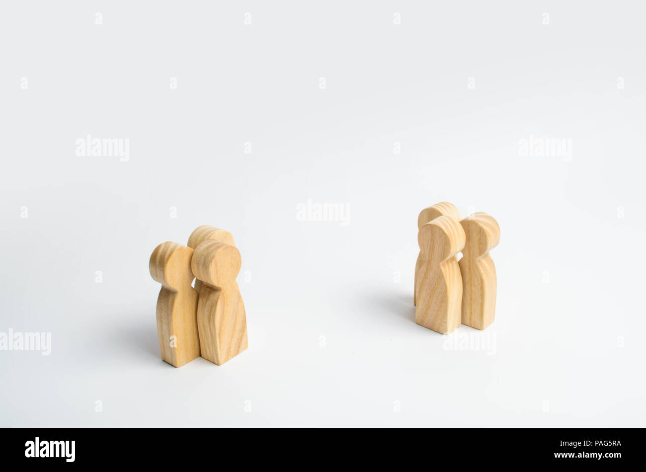 Two groups of people stand opposite each other on a white background ...