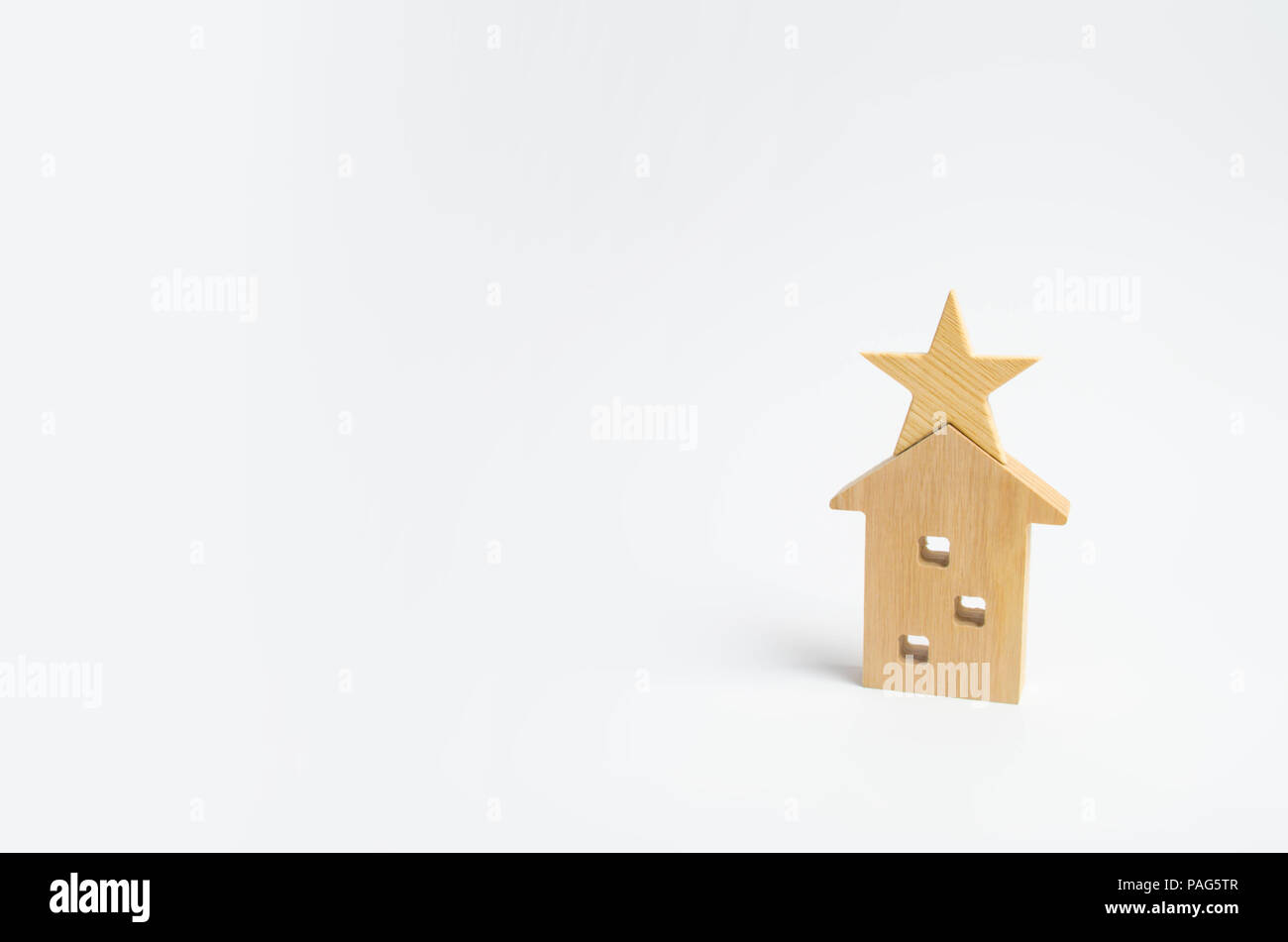 Wooden house with a star on a white background. The concept of luxury ...