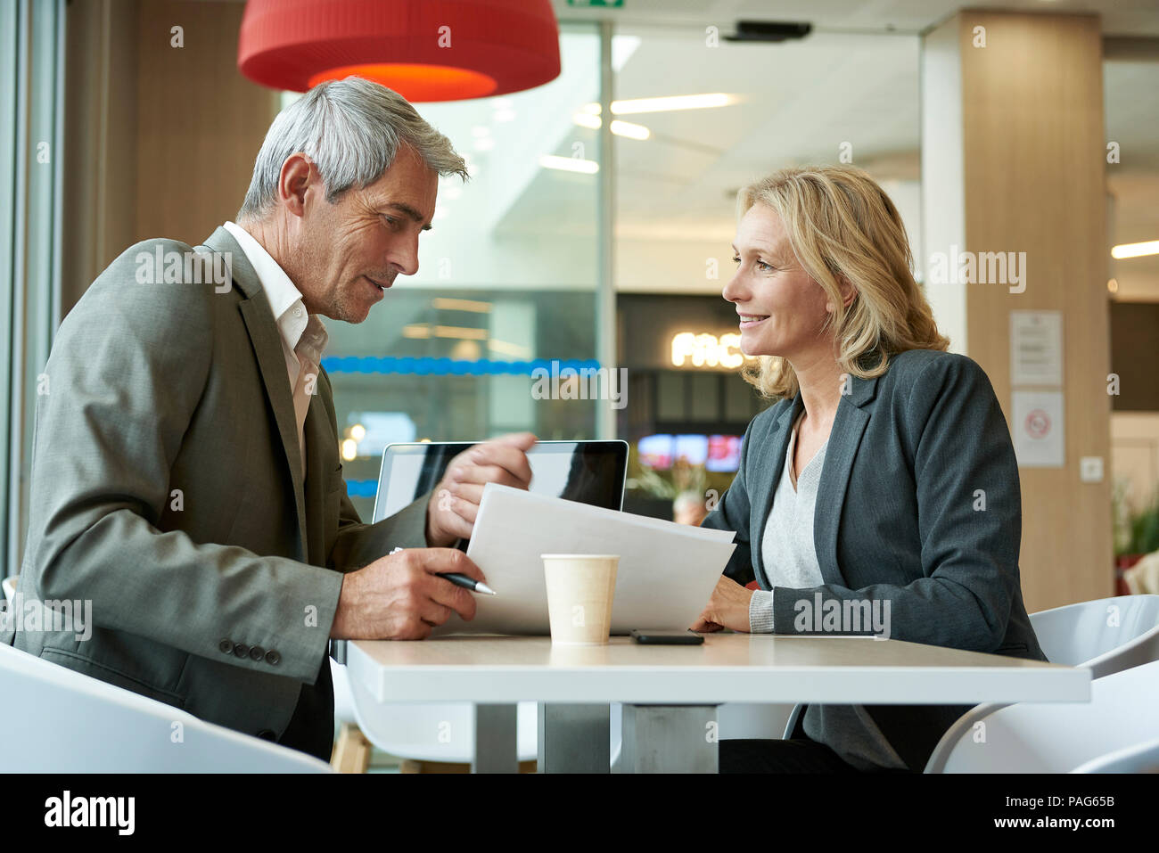 Two colleagues discussing contract hi-res stock photography and images ...