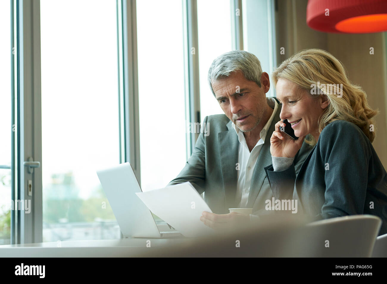 Businesspeople working in cafeteria Stock Photo - Alamy
