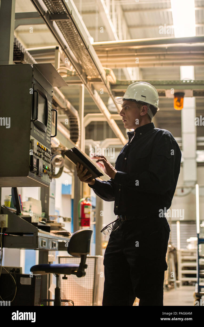Worker holding control panel factory hi-res stock photography and ...