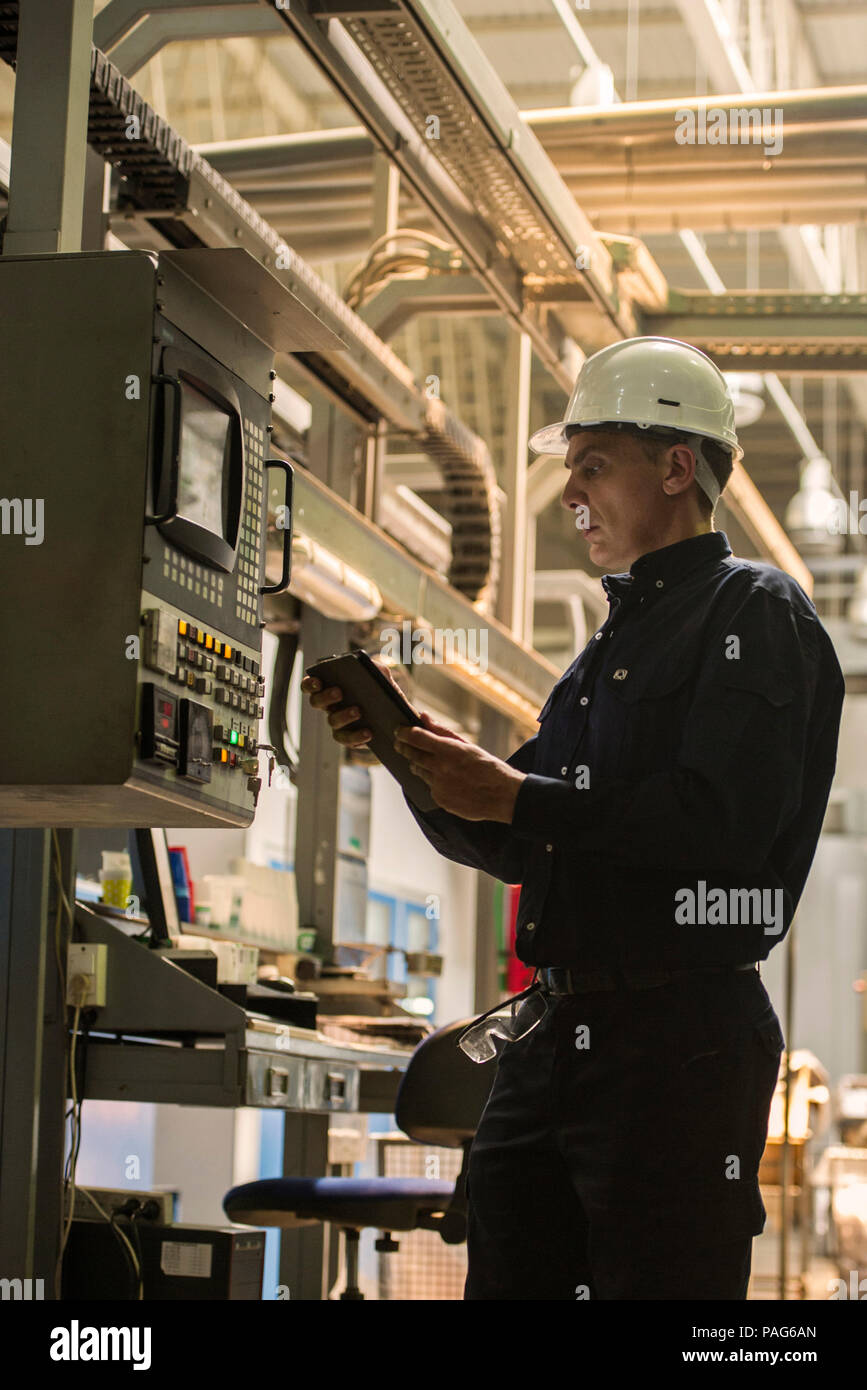 Worker holding control panel factory hi-res stock photography and images - Alamy