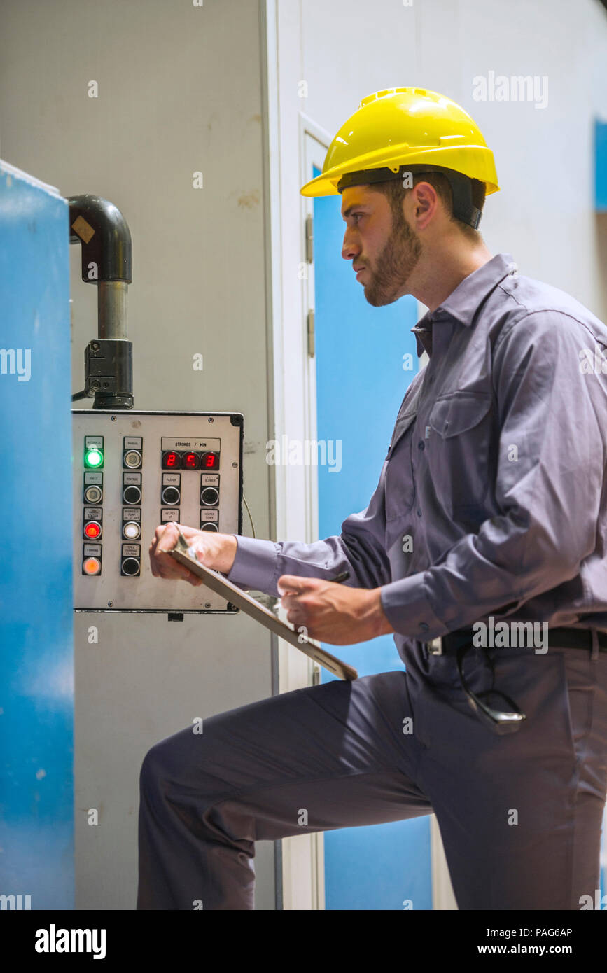 Worker holding control panel factory hi-res stock photography and ...