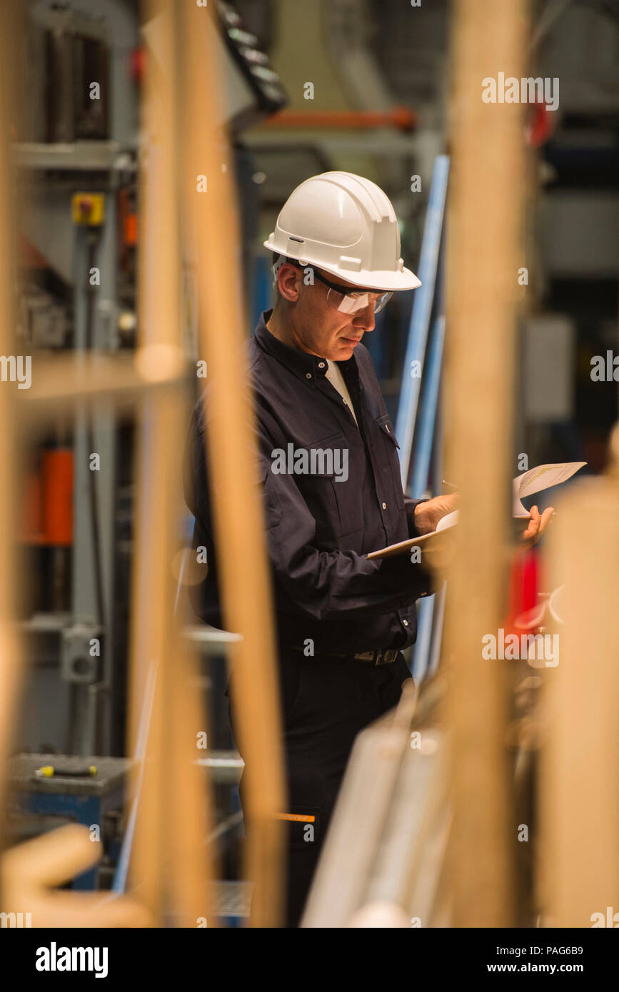 Factory worker holding paper clipboard hi-res stock photography and ...