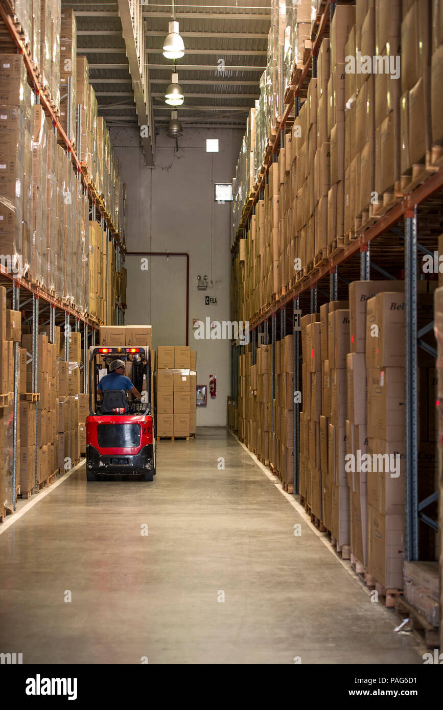 Worker operating forklift truck Stock Photo - Alamy