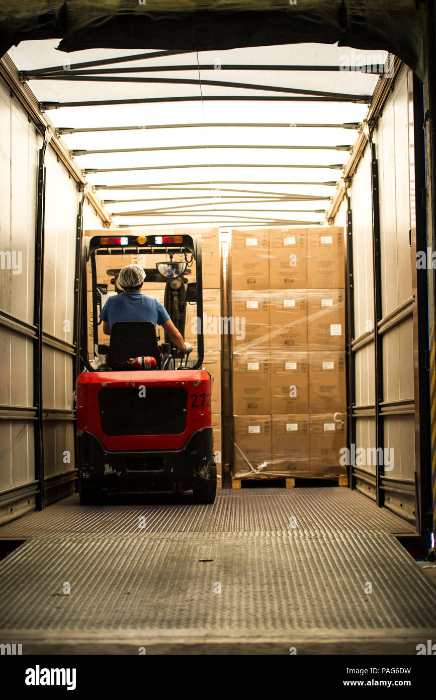 Man loading cardboard boxes in lorry Stock Photo - Alamy