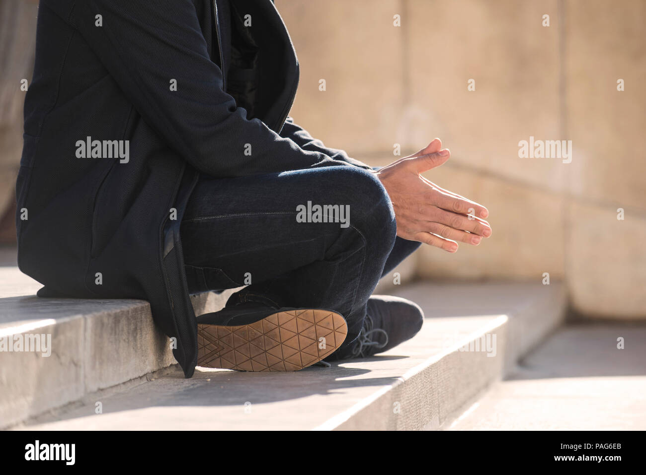 Man sitting on steps Stock Photo - Alamy