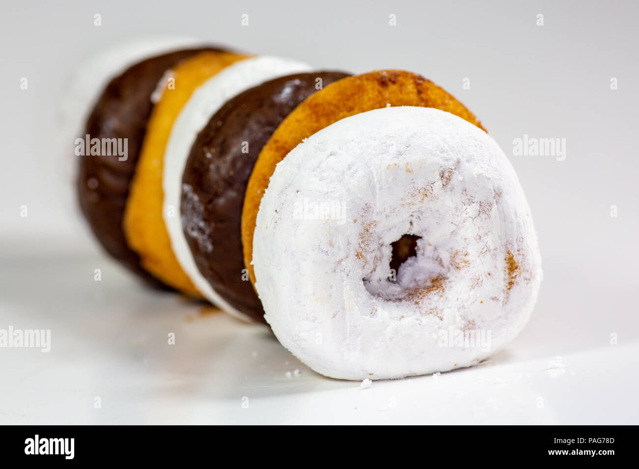 An assortment of donuts, powder donuts, chocolate donuts and plain ...