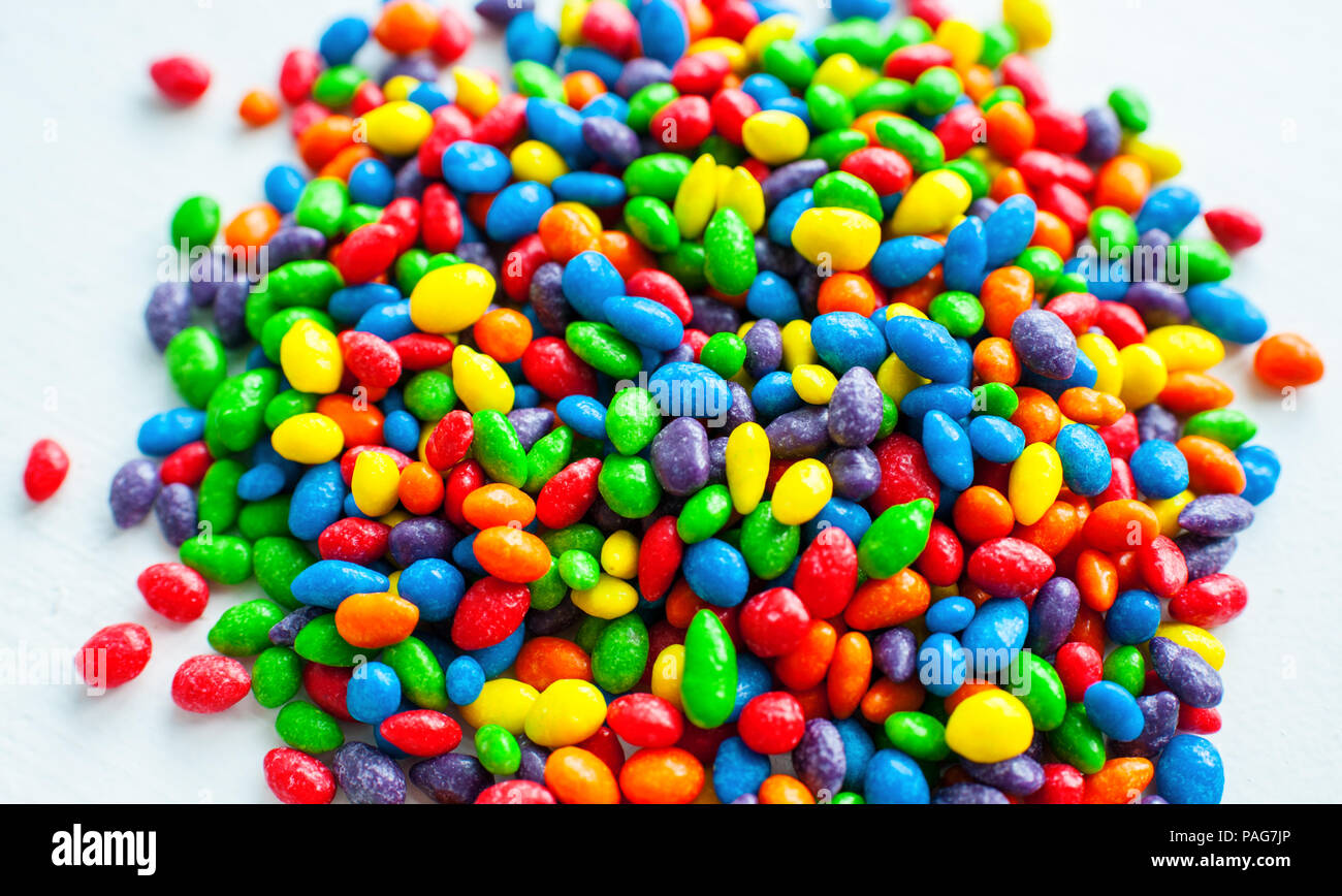 Multi-colored dragee on a white background Stock Photo - Alamy