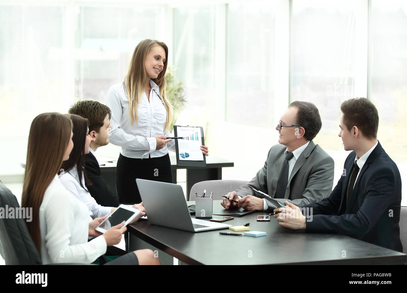 Businesswoman explaining business plan to her colleagues Stock Photo ...