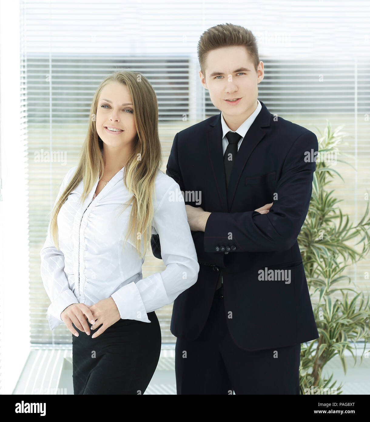 business couple standing in a modern office Stock Photo - Alamy