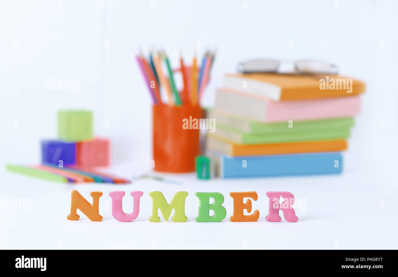 word number on blurred background of school supplies .photo with copy ...