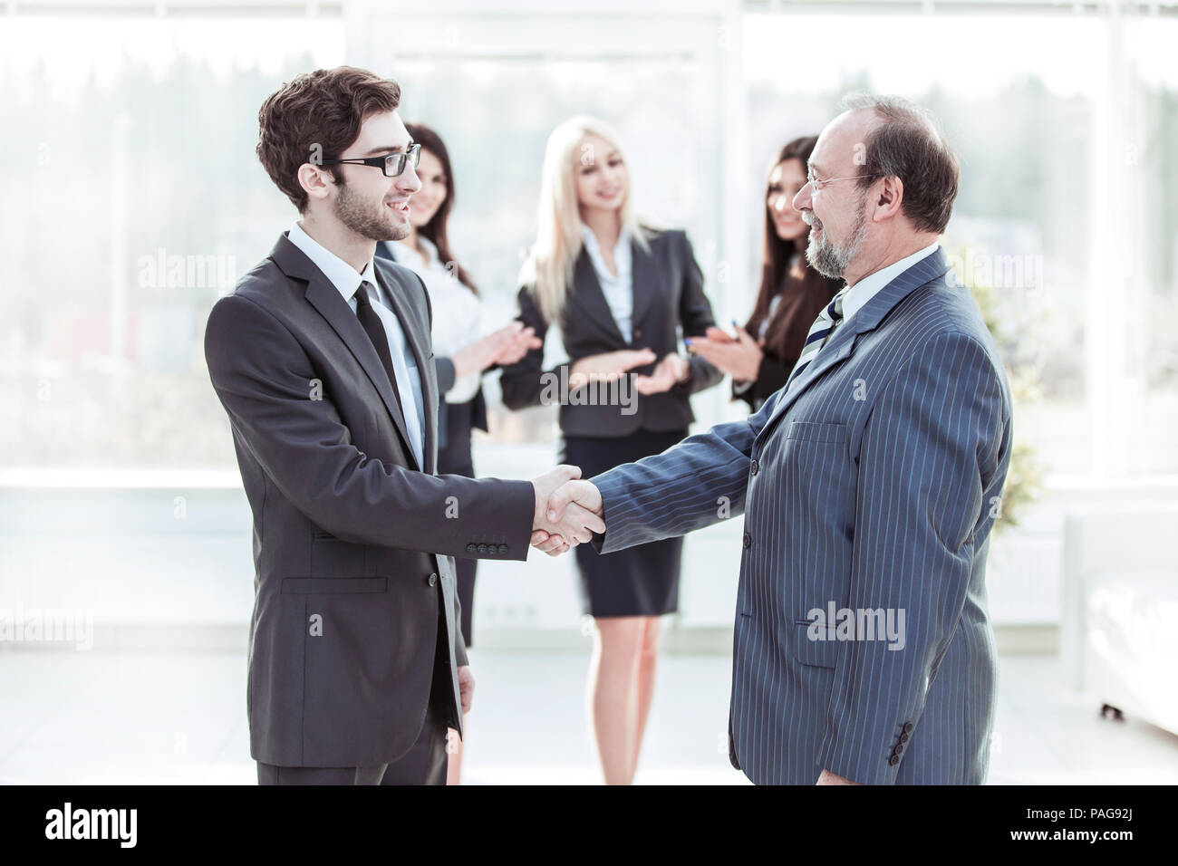 welcome and handshake of business partners on the background of ...