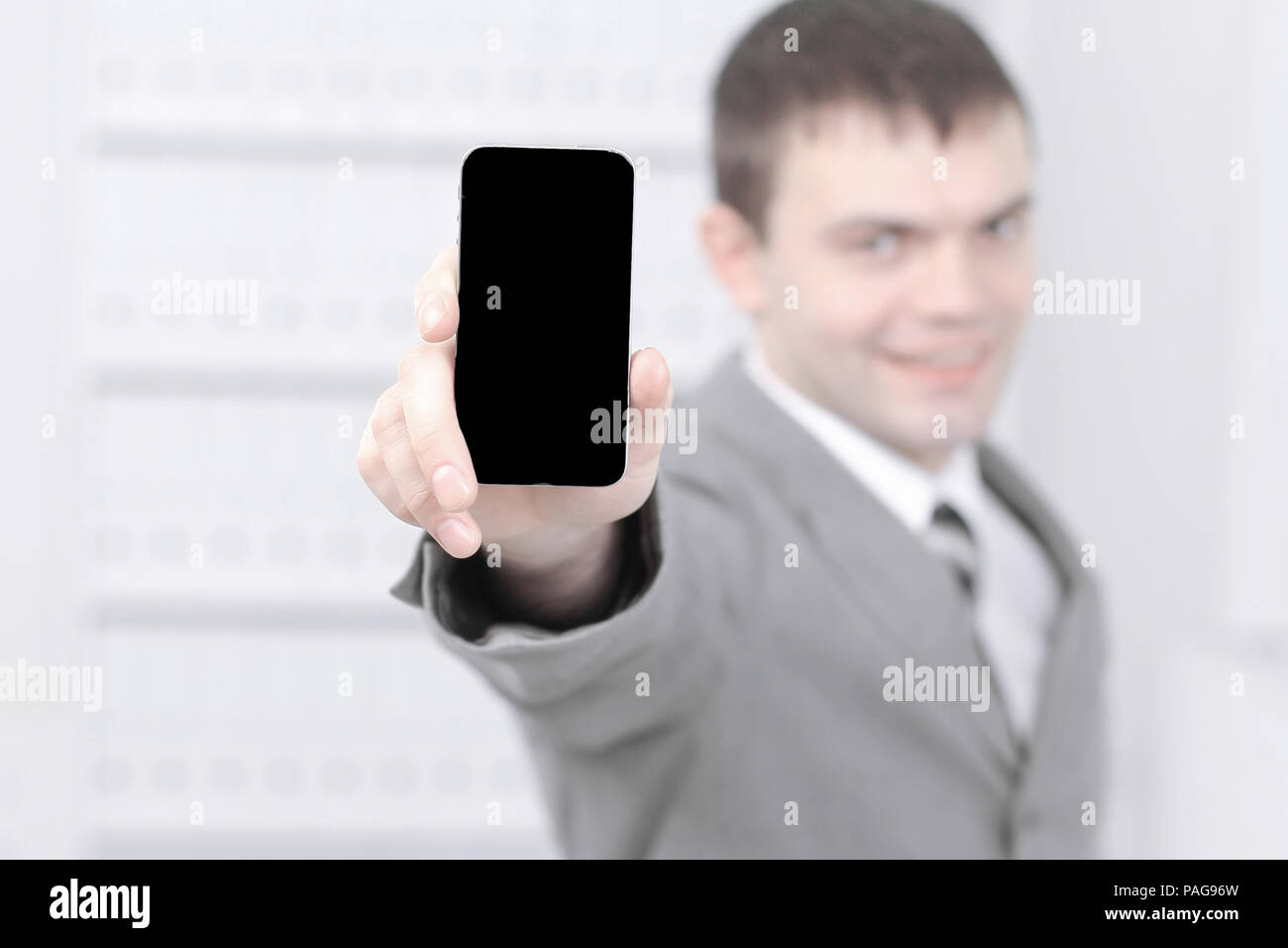 man showing screen of smartphone ,while standing in the office Stock ...
