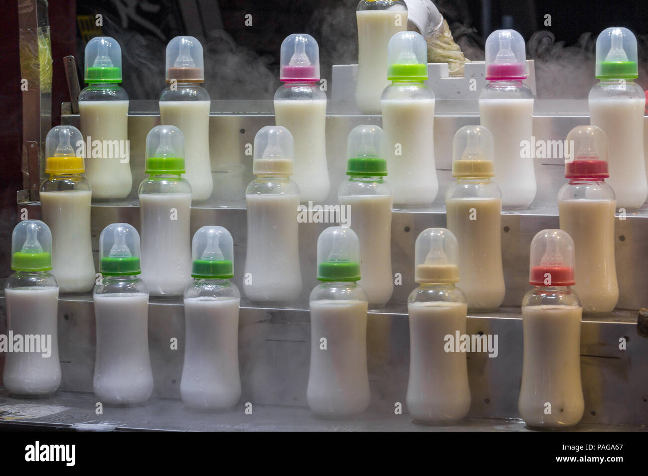 Section of freshly prepared milk drinks in shop-window counter in the ...