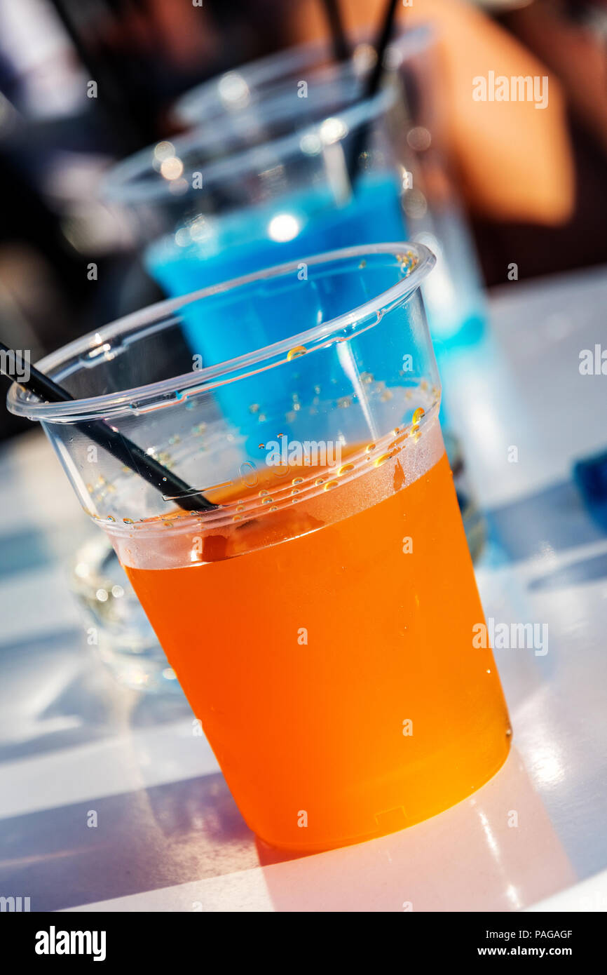 Orange and blue cocktails in plastic bottle in summer Stock Photo - Alamy