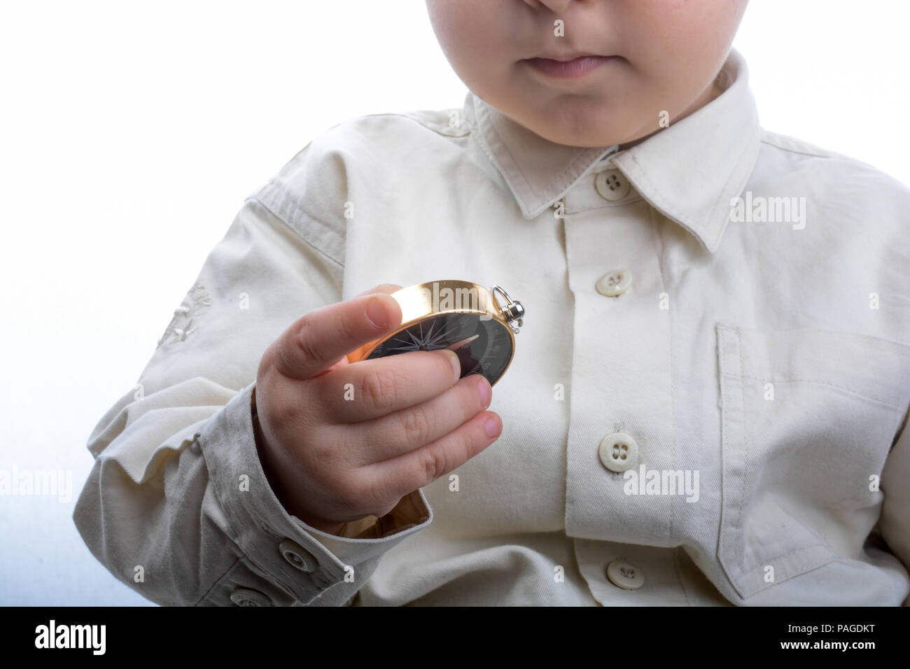 Isolated compass in baby's hand on a white background Stock Photo - Alamy