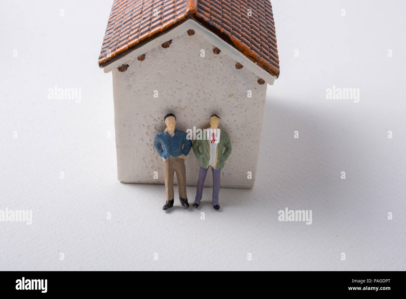 Tiny figurine of man miniature before a house Stock Photo - Alamy