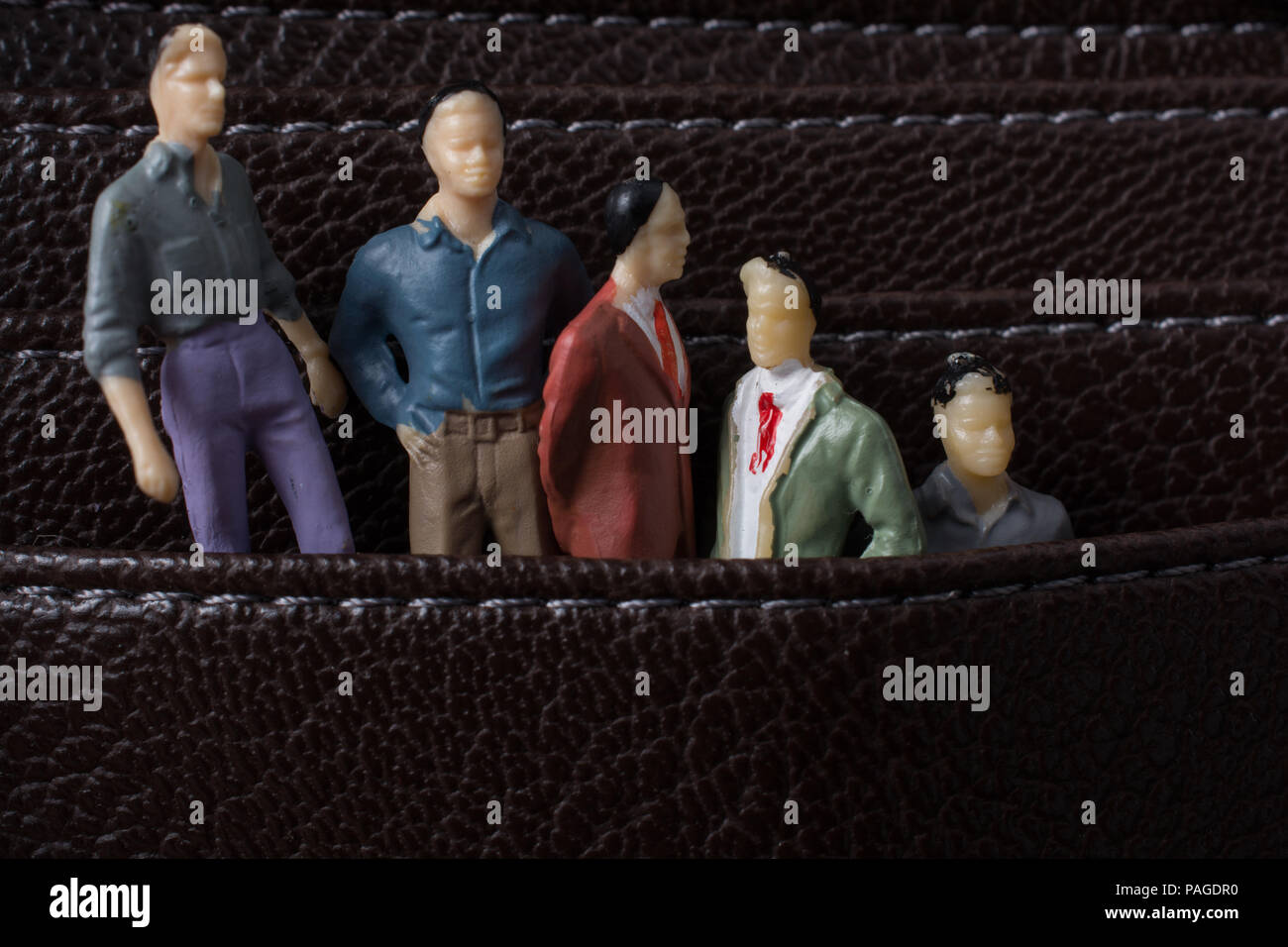 Tiny figurine of group of men miniature model in pockets Stock Photo ...